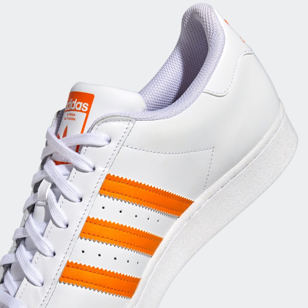 Striped Statement: Orange Stripe Adidas Shoes For Men
